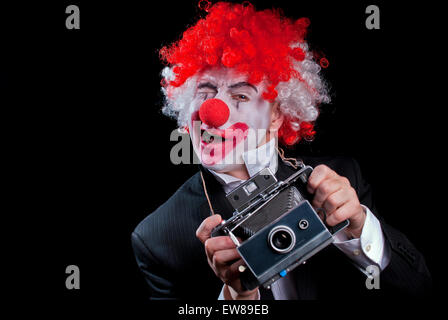 colorful clown with an instant camera on a black background Stock Photo ...
