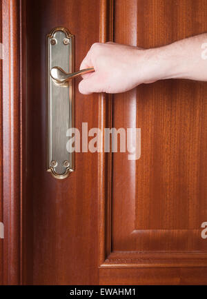 Hand gripping the handle of a door inside home Stock Photo - Alamy