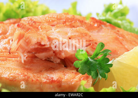 Pan fried salmon patty served on lettuce Stock Photo - Alamy