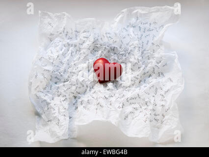 Red paper with word love and heart shapes on wooden table Stock Photo ...