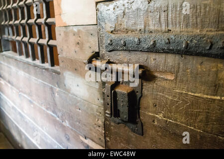 Heavy wooden medieval prison cell door with open hatch showing prisoner ...