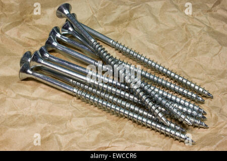 Screws on vintage paper Stock Photo - Alamy