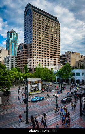 A scenic view of modern buildings on the coast of an ocean with boats ...