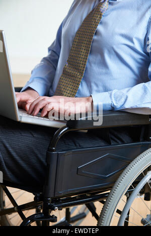 Disabled businessman on wheelchair working home Stock Photo - Alamy
