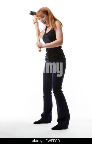 mad woman swing a sledge hammer over her head at the ground Stock Photo ...