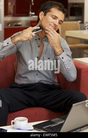 Man shaving with electric razor Stock Photo - Alamy