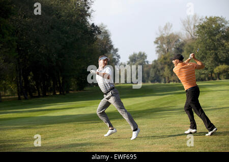 Friends having fun in golf course Stock Photo - Alamy
