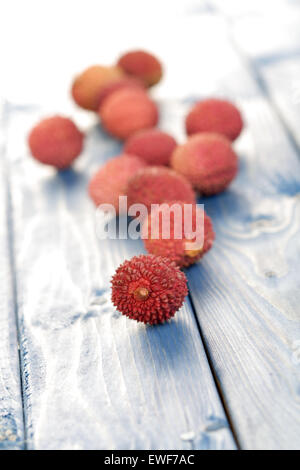 Lychees cut fruit over wooden table Stock Photo - Alamy