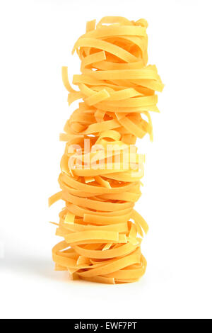 Row pasta on flour background Stock Photo - Alamy