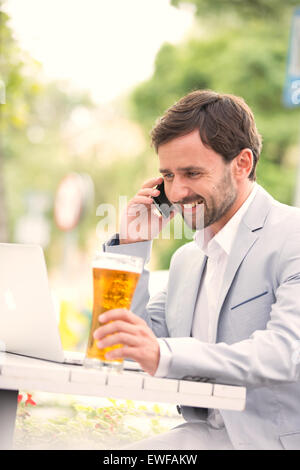 Man holding glass of beer on blurred urban city background with ...