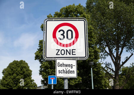 Road sign Tempo 30 Zone, one-family house in the background, Germany ...
