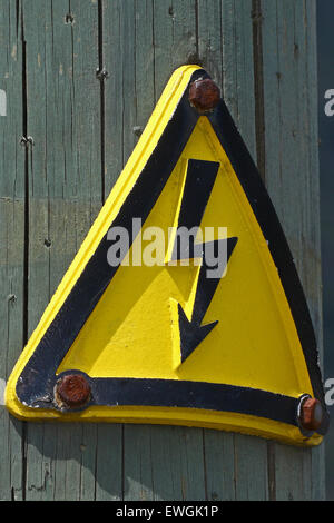 Old, rusty high voltage warning sign Stock Photo - Alamy