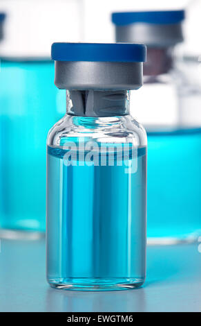 Vials of the vaccine, blue background Stock Photo - Alamy
