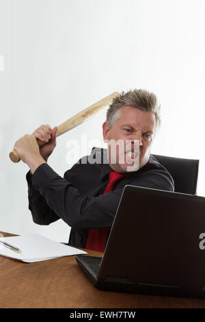 businessman getting very mad about to hit his computer with a Stock ...
