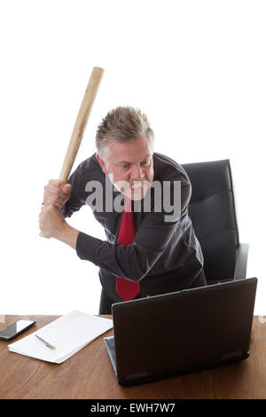 businessman getting very mad about to hit his computer with a baseball ...