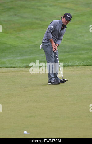 Brian Harman watches his putt on the 18th green during the second round ...