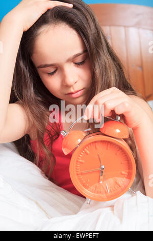 Shocked scared woman waking up from a nightmare in her bed at night ...