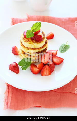 cottage cheese pancakes on a plate, blackberries, sour cream. br Stock ...