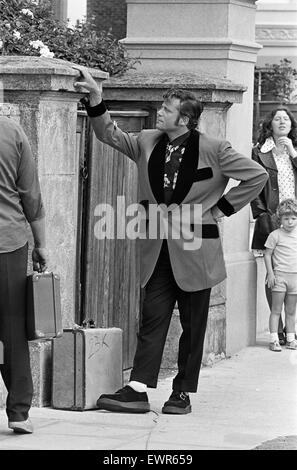 Actor Oliver Reed dressed in Teddy Boy clothing during a break in ...