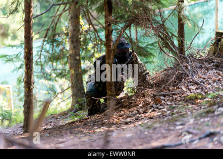Paintball Players Hide Behind Tree Stock Photo - Alamy