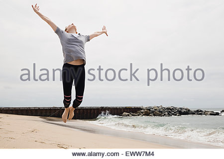Carefree woman jumping with joy enjoying life. Female person ...