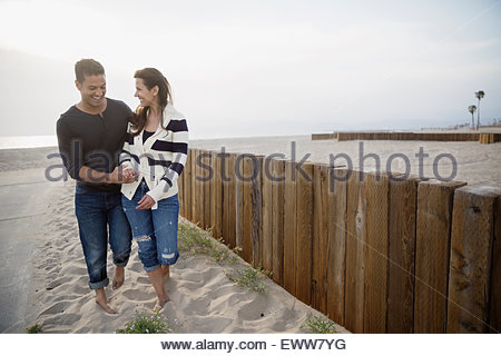 People walking along a wall Stock Photo - Alamy
