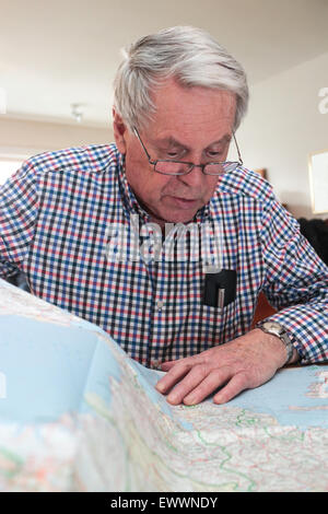 Old male tourist preparing for trip at home Stock Photo - Alamy
