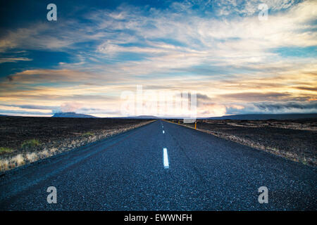 Road leading into the distance under a dramatic sky Stock Photo - Alamy