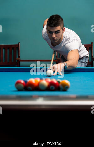 Young Men Lining To Hit Ball On Pool Table Stock Photo - Alamy