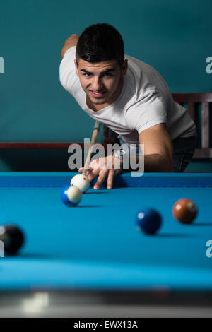 Young Men Lining To Hit Ball On Pool Table Stock Photo - Alamy