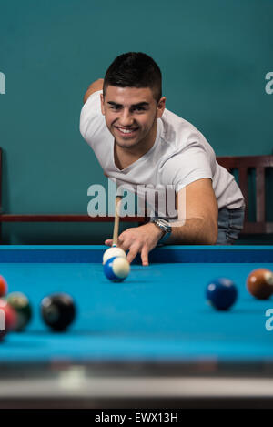 Young Men Lining To Hit Ball On Pool Table Stock Photo - Alamy