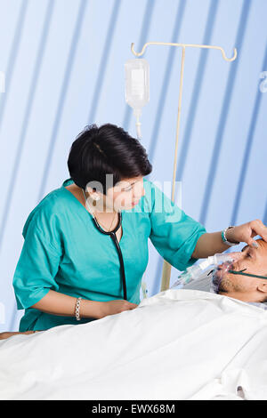 back view of indian doctor checking breath of his african american ...