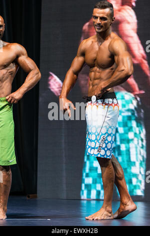 Mens Physique Posing During A Bodybuilding Competition Stock Photo - Alamy