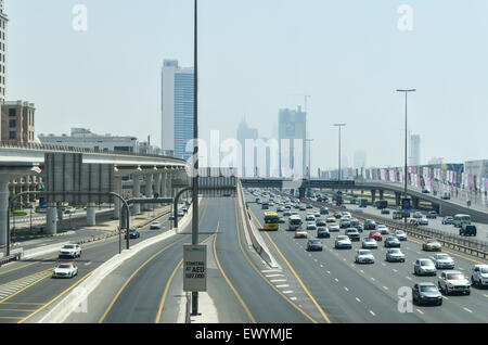 Dubai car traffic on modern seven lane motorways and RTA gantry signs ...