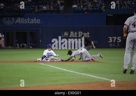 Baseball player sliding into second base as throw arrives from third ...