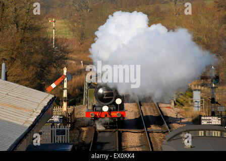 Steam train leaving station Stock Photo - Alamy
