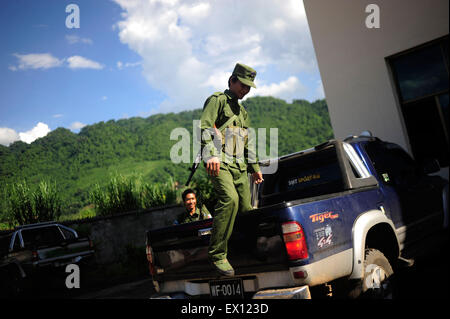 A Myanmar policeman patrols a street in Namteuk, neighbouring China's ...