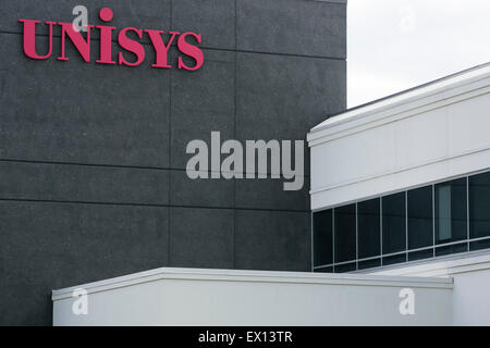 A logo sign outside of the headquarters of Unisys Corporation in Blue ...
