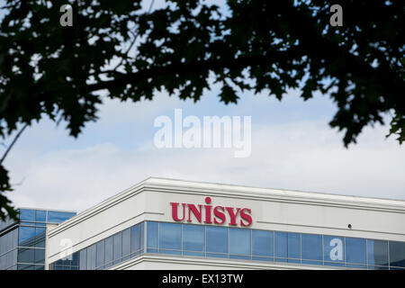 A logo sign outside of the headquarters of Unisys Corporation in Blue ...