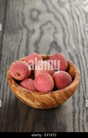 Bowl of lychees on white wooden table Stock Photo - Alamy