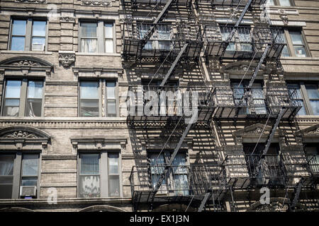 Fire escapes on tenement apartment buildings in Harlem neighborhood ...