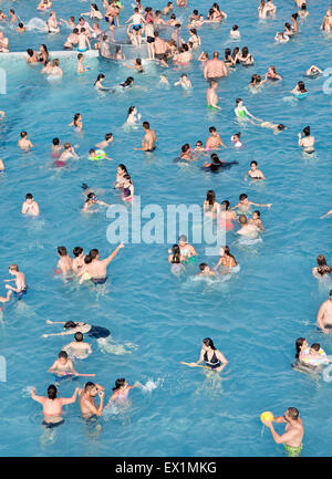 Nuremberg, Germany. 3rd July, 2015. A bather jumps into a large outdoor ...