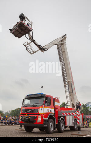 Firefighters are demonstrating turntable ladder-type firetruck system ...