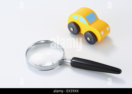 Wooden toy car and magnifying glass Stock Photo - Alamy