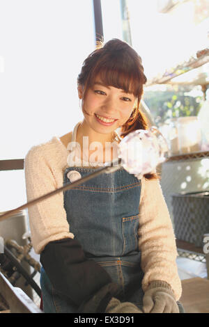 Pretty Asian young woman sit on mound seeking Binoculars Stock Photo ...