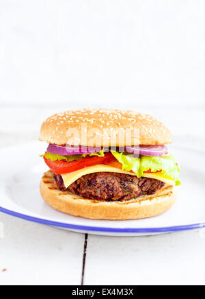 Gourmet Burger on Blue Plate with Roasted Peppers Stock Photo - Alamy