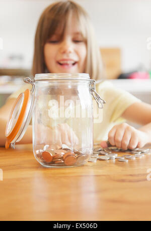 coins inside jar glass Stock Photo - Alamy