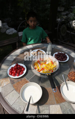 Family eating breakfast in the courtyard Stock Photo - Alamy