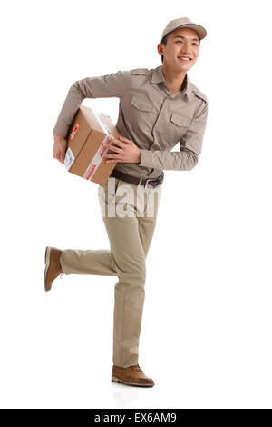 Portrait of young man holding package Stock Photo - Alamy