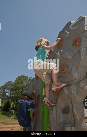 Child playing basketball during an outdoor physical education class ...